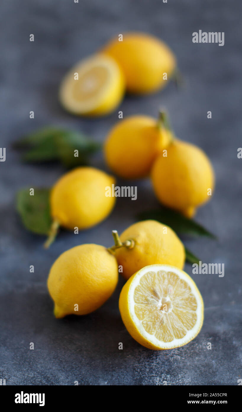 Fresh lemons on a grey background Stock Photo - Alamy