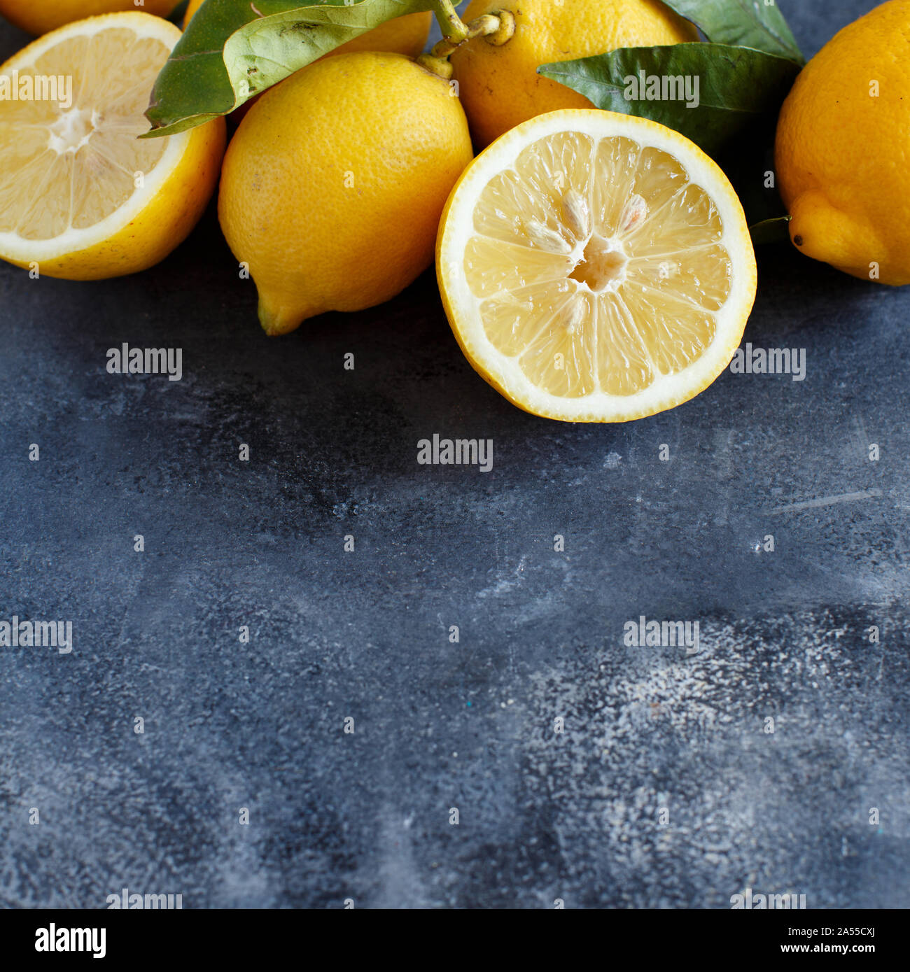 Fresh lemons on a grey background Stock Photo - Alamy