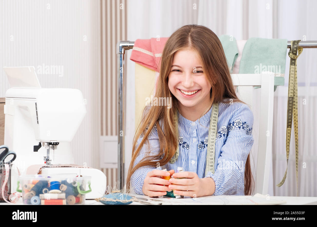Teenage girl in tailor workshop Stock Photo - Alamy