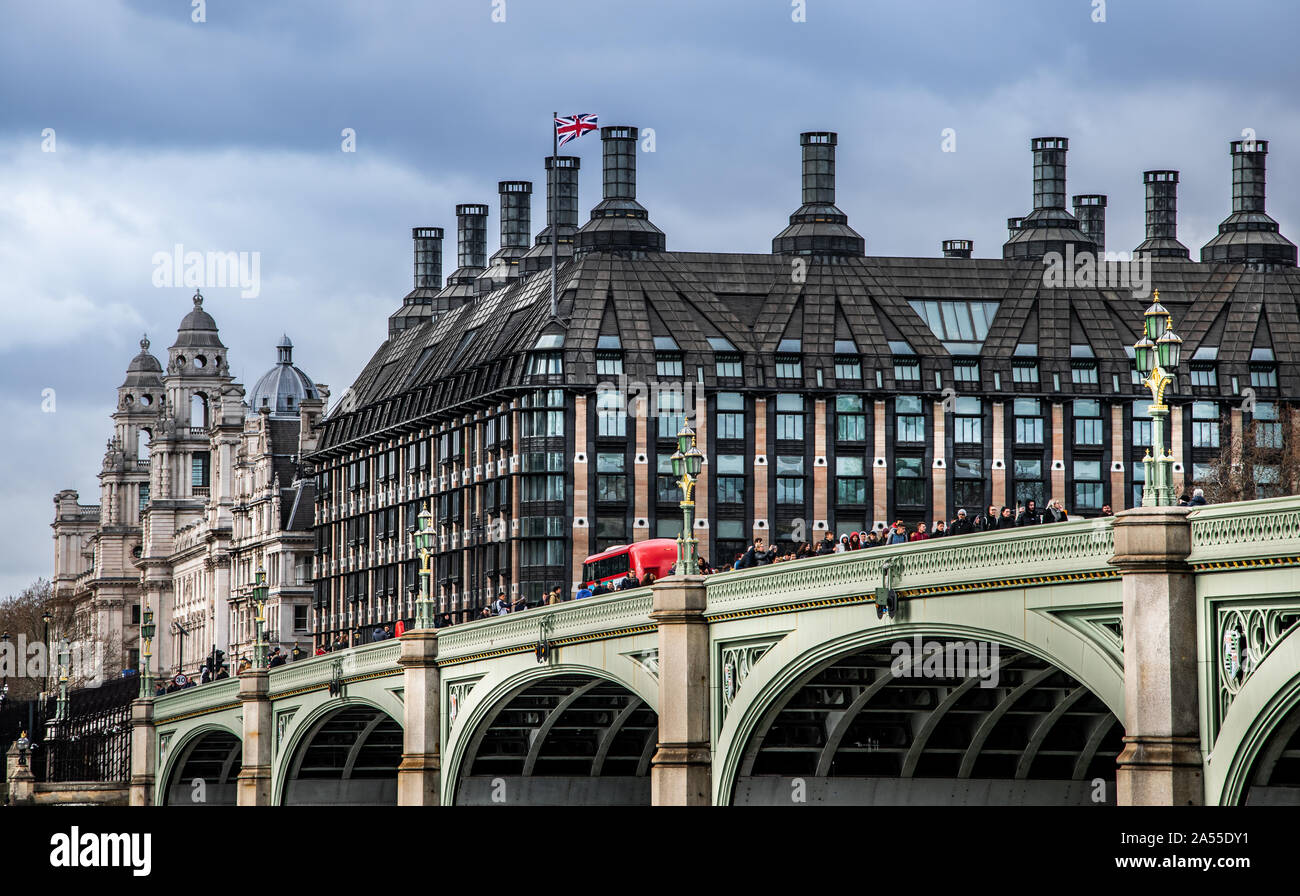 The very crowded Westminster Bridge in London,UK. Red bu crossing the ...
