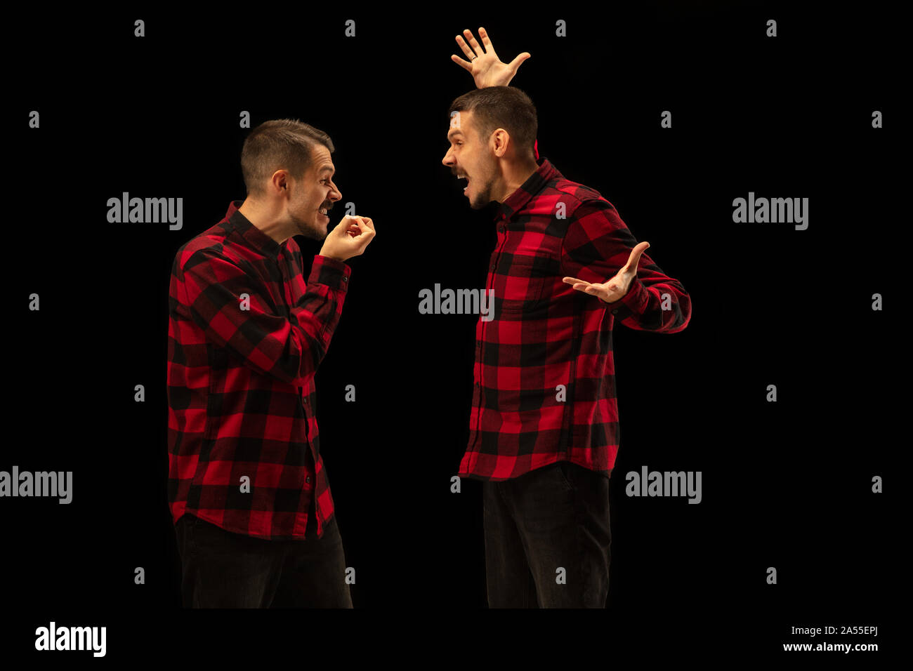 Young handsome man arguing with himself on black studio background ...