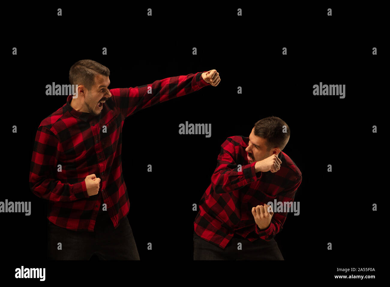 Young handsome man arguing with himself on black studio background ...