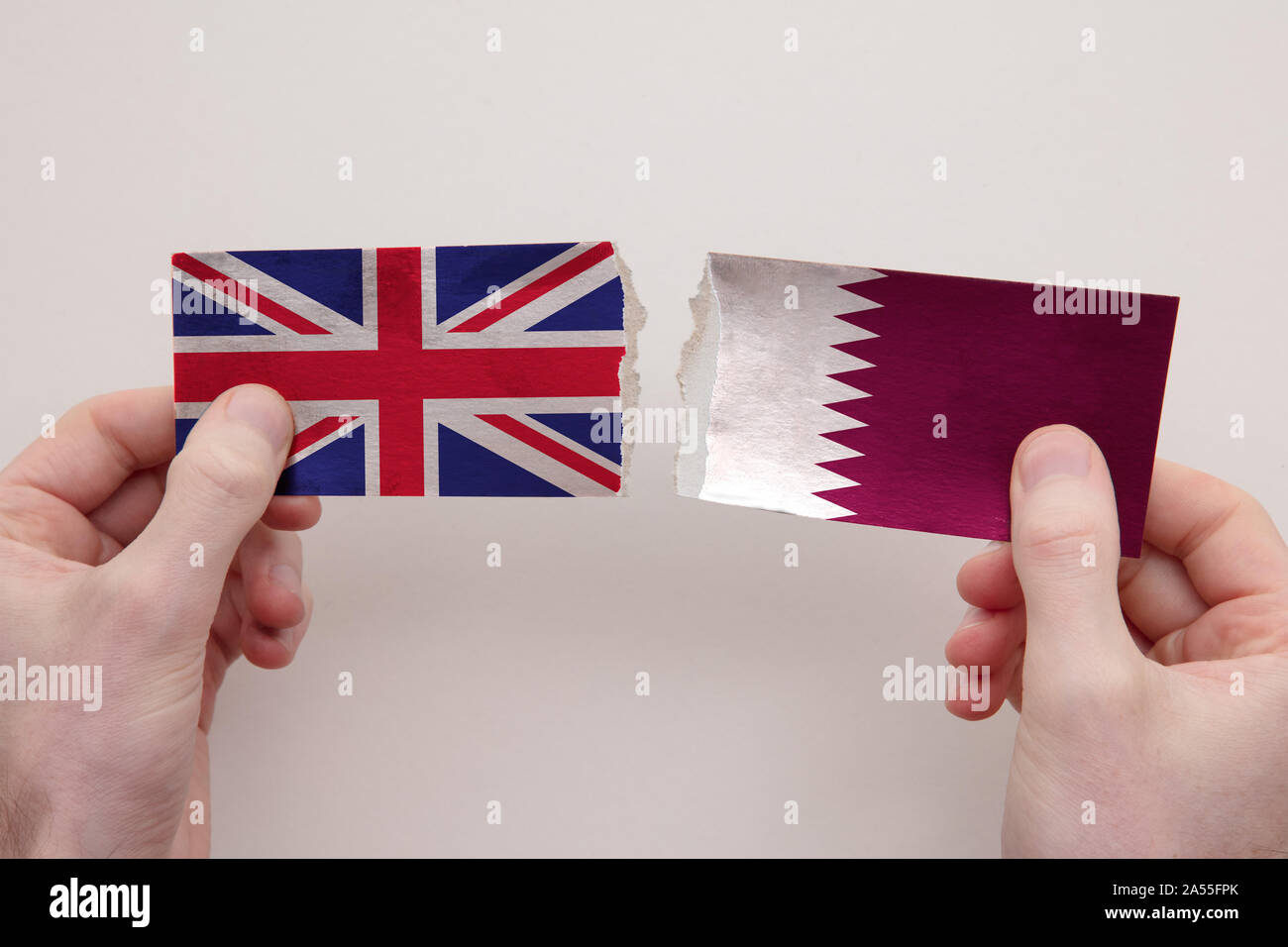 UK and Qatar paper flags ripped apart. political relationship concept ...