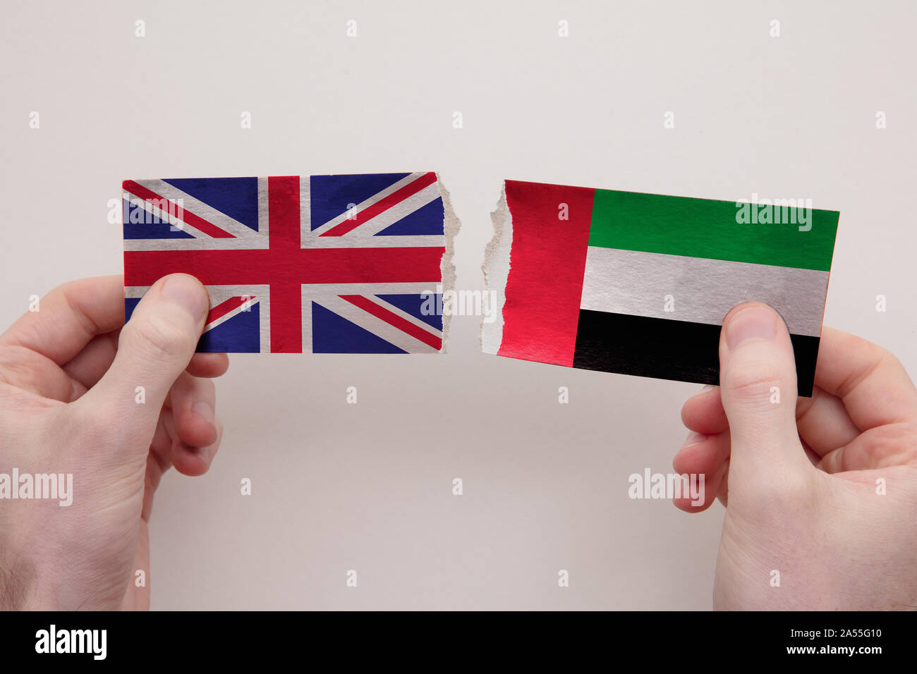 UK and UAE paper flags ripped apart. political relationship concept ...