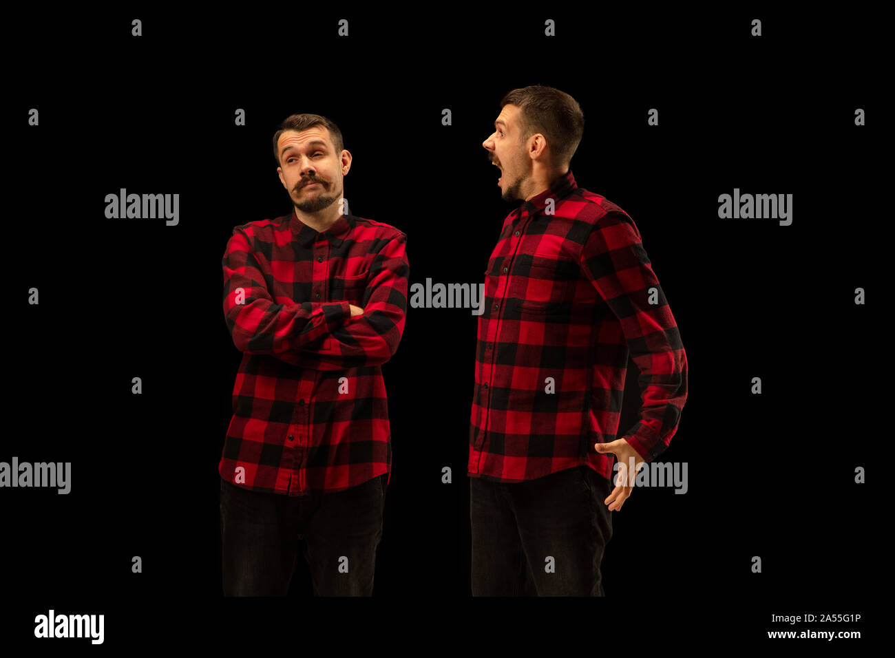 Young handsome man arguing with himself on black studio background ...