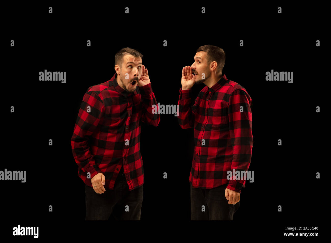 Young handsome man arguing with himself on black studio background ...