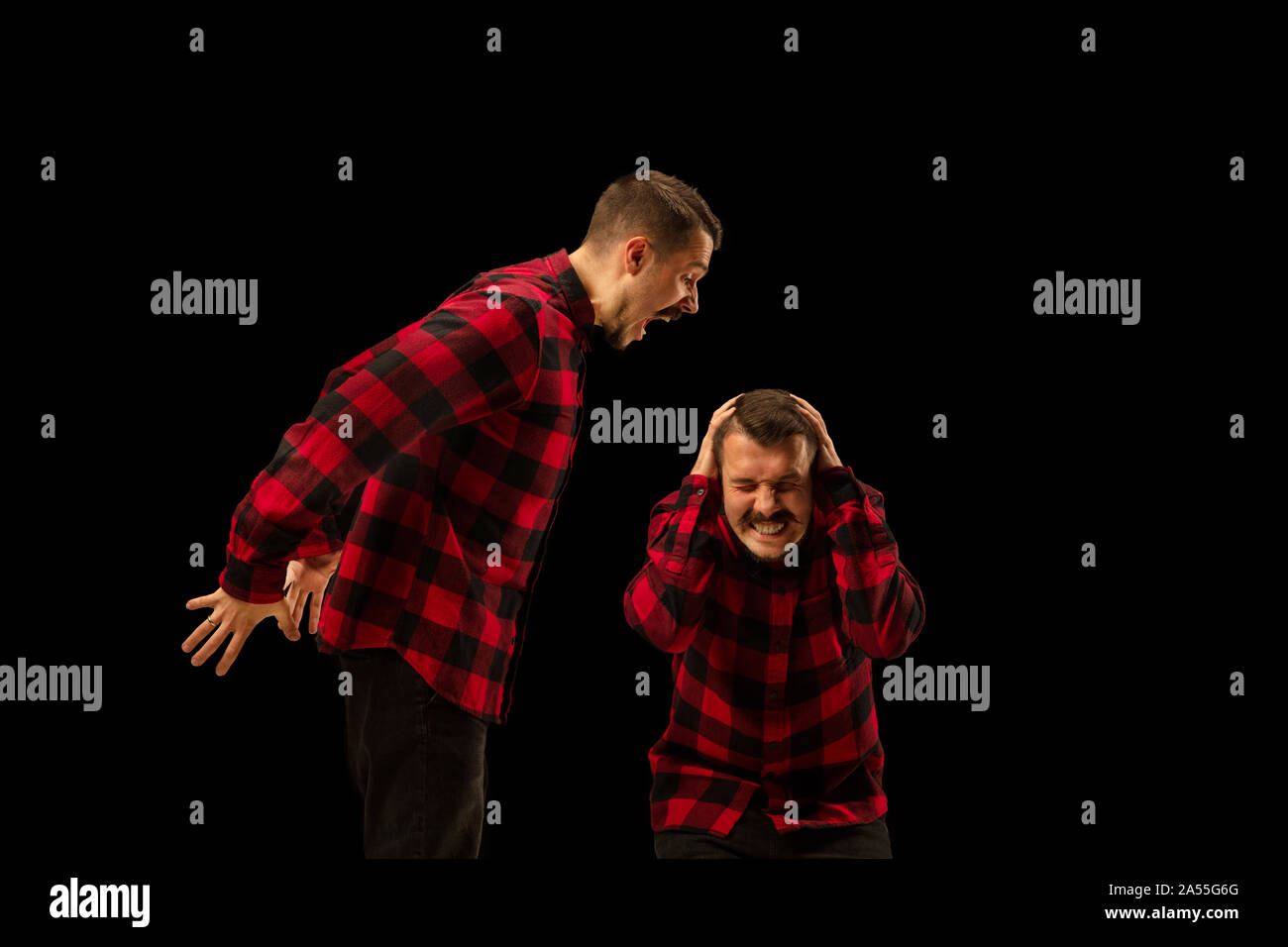 Young handsome man arguing with himself on black studio background ...