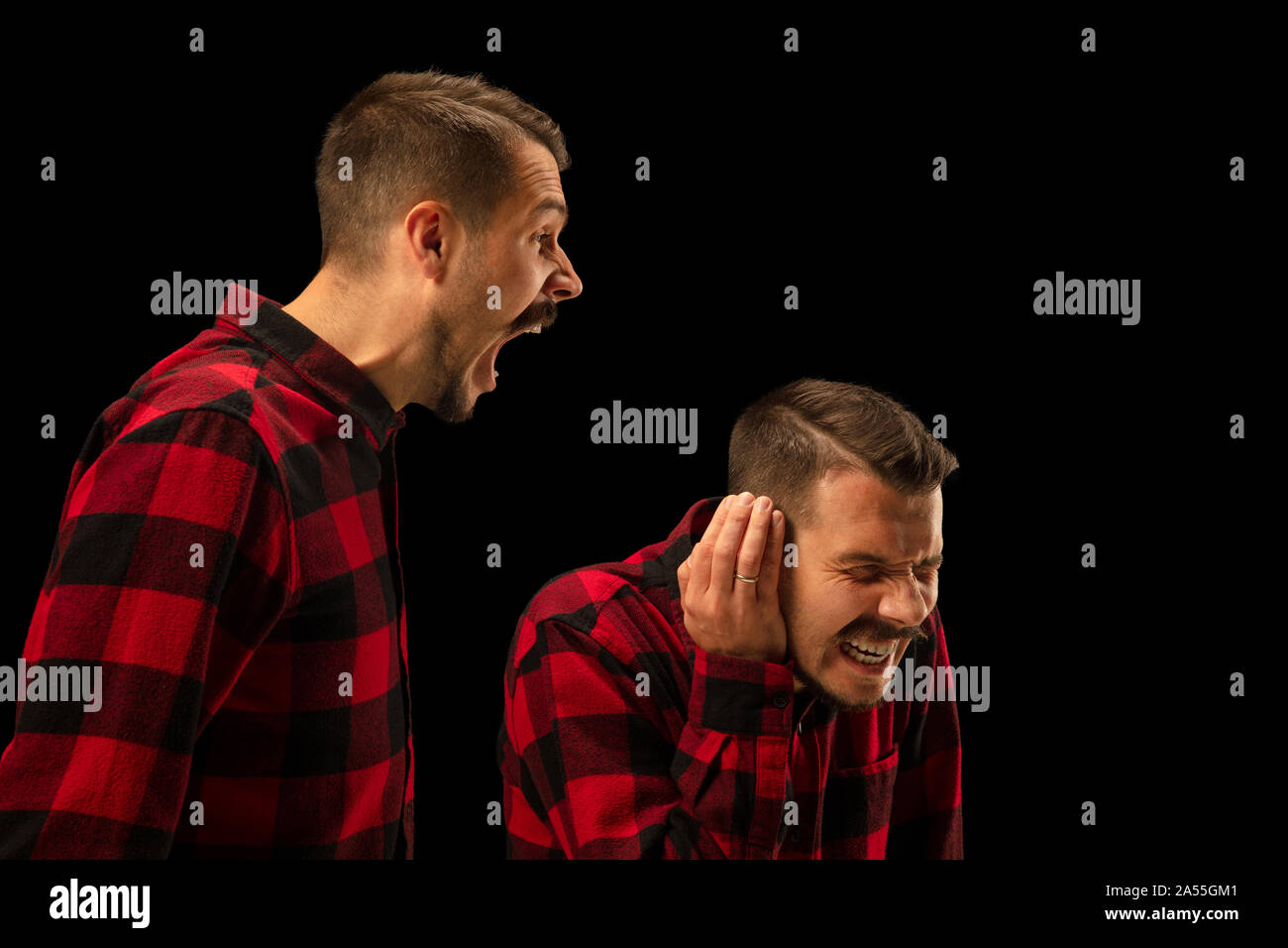 Young handsome man arguing with himself on black studio background ...