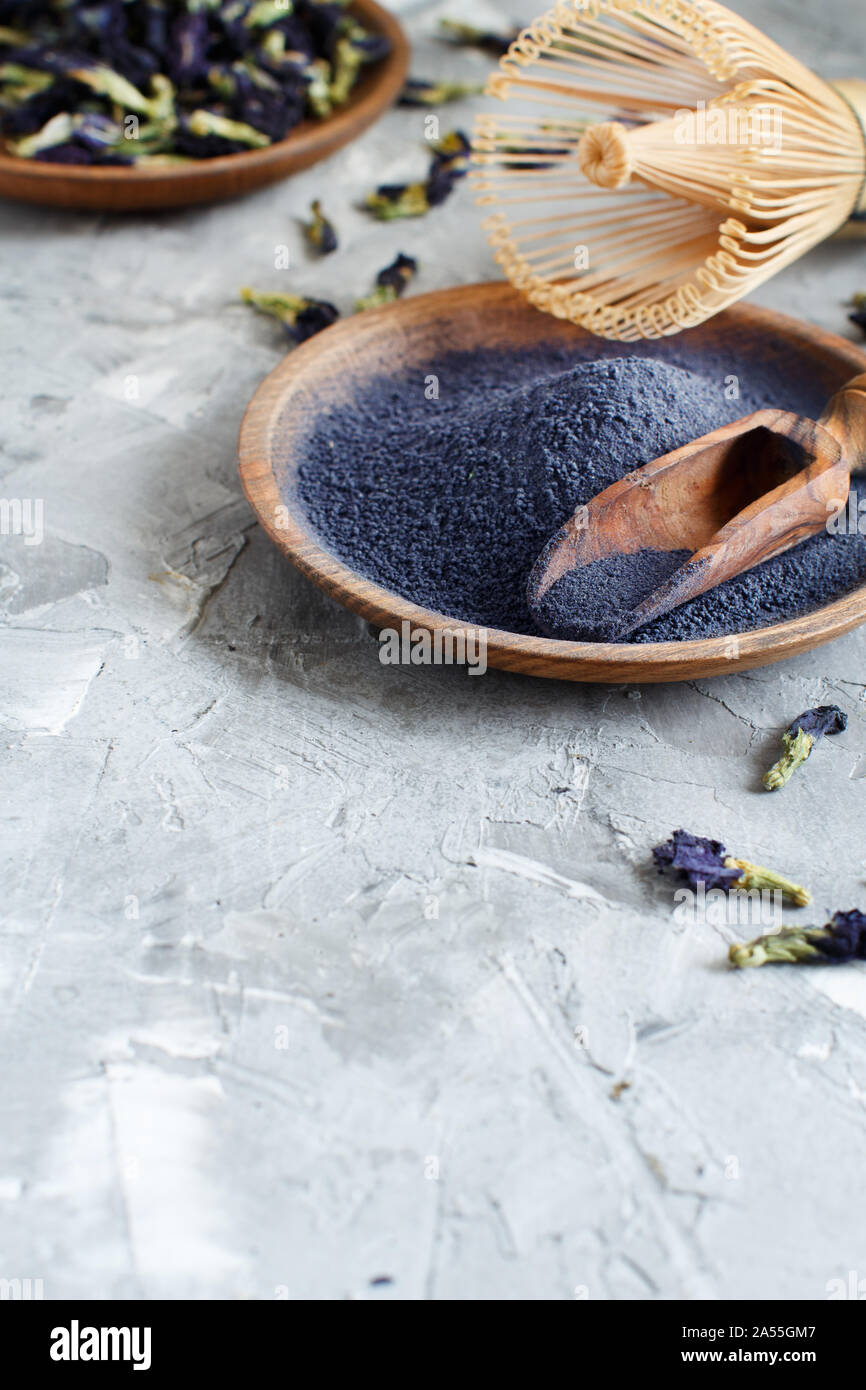 Butterfly pea blue matcha powder word with wrisk and dried flowers ...
