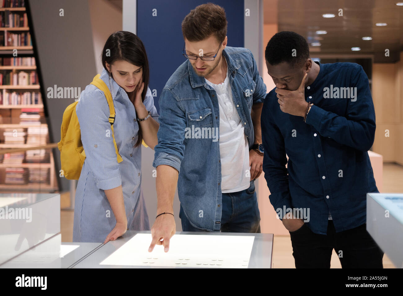 Multicultural group of students in a public library Stock Photo - Alamy