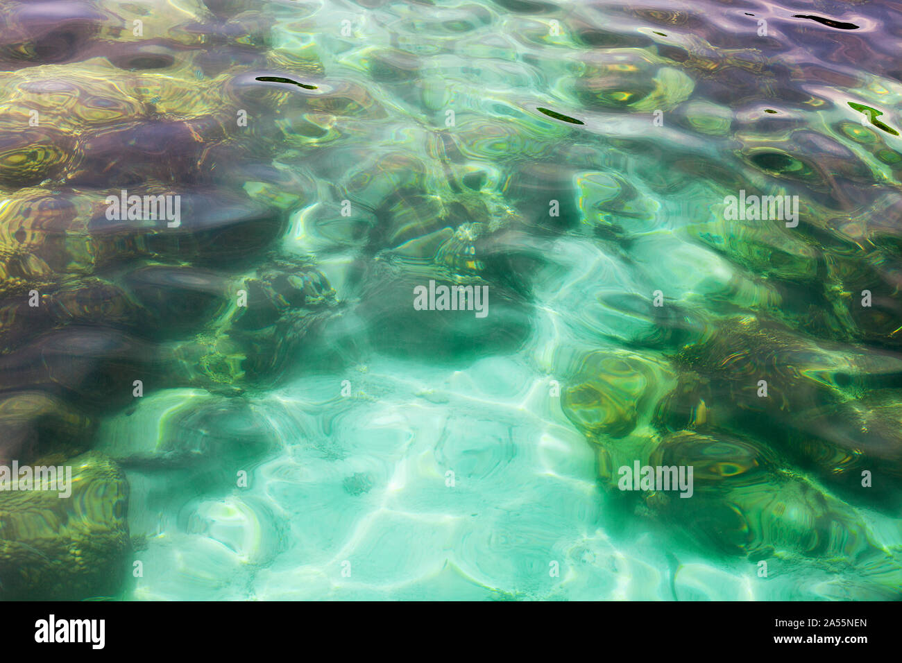 Blue crystal clear sea water, stones texture background, turquoise ...