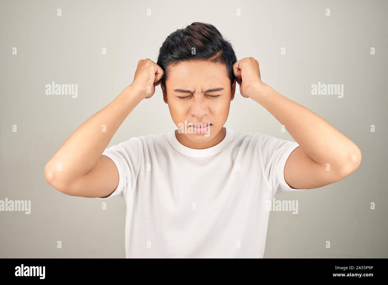 People, stress, tension and migraine concept. Upset unhappy young man ...