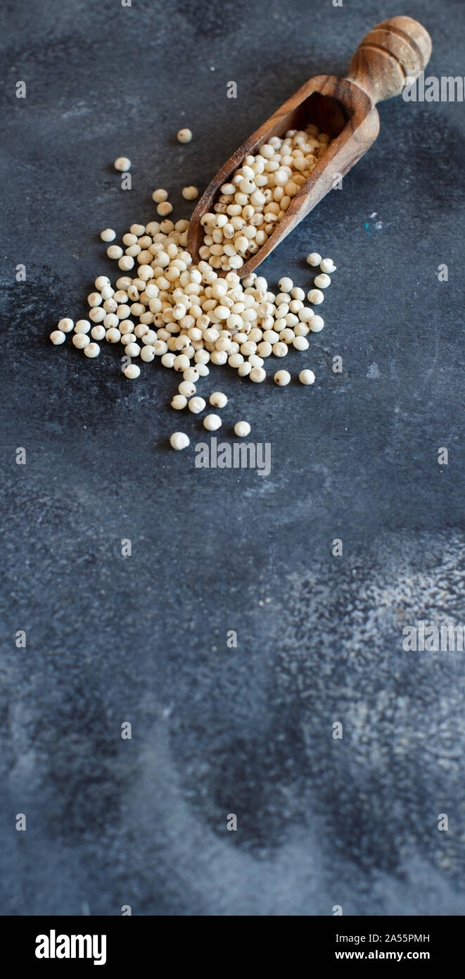 Raw White Sorghum grain in a bowl on a grey table Stock Photo - Alamy