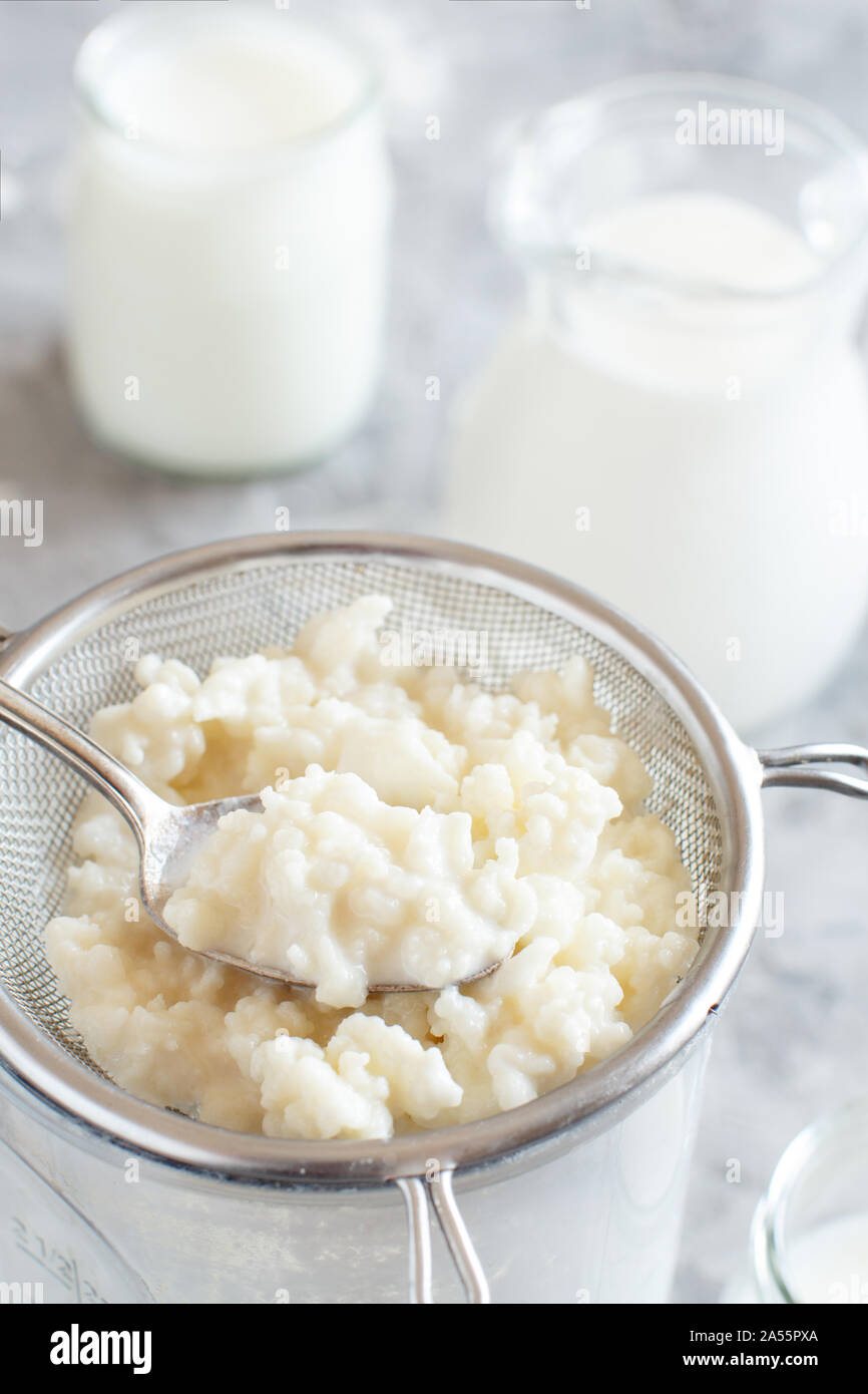 Kefir grains and fermented drink kefir close up Stock Photo - Alamy