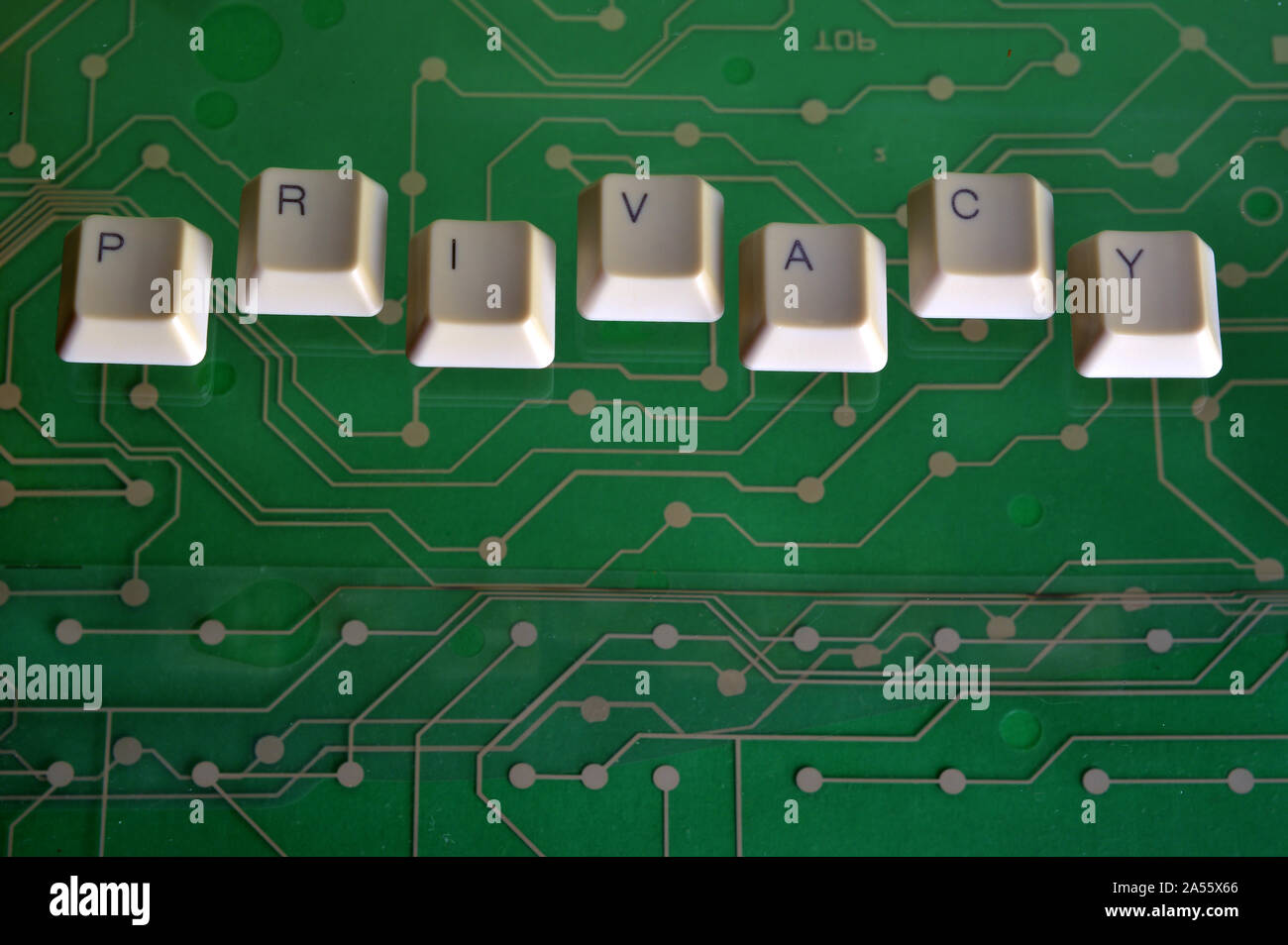 Keyboard keys form the word PRIVACY on green electric circuit in the ...