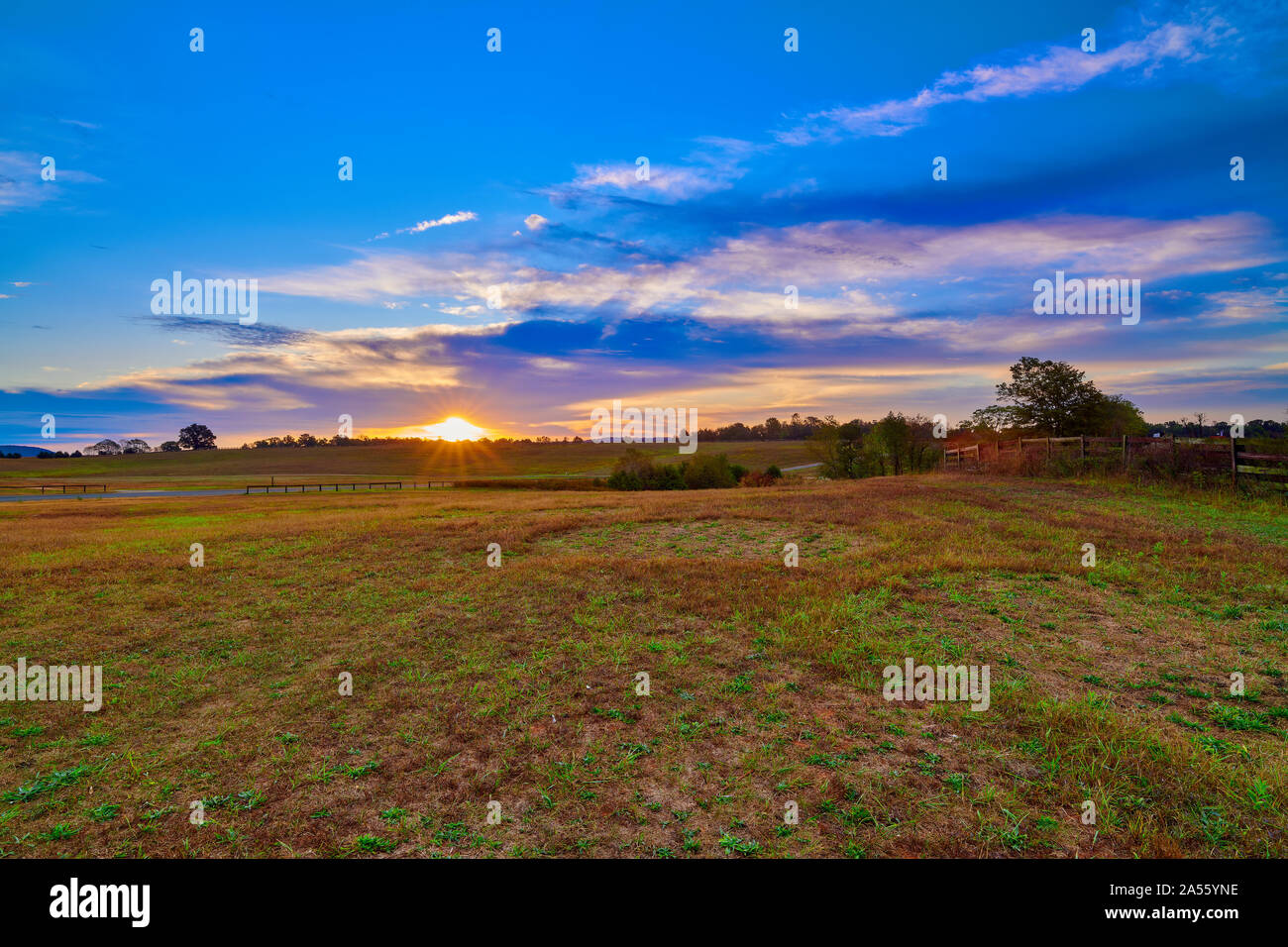 Sunrise over an open field Stock Photo - Alamy