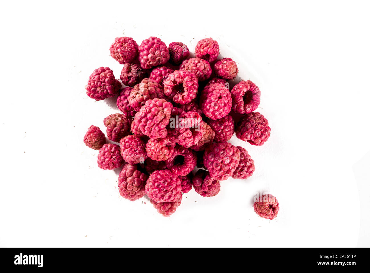 Heap of sun dried raspberries isolated on white background. Top view ...