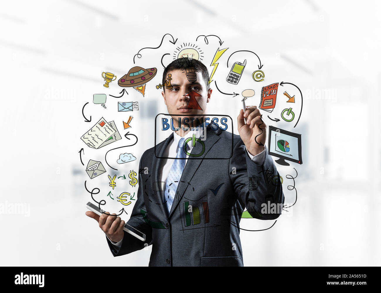 Handsome businessman standing and pointing at business doodles. Front ...