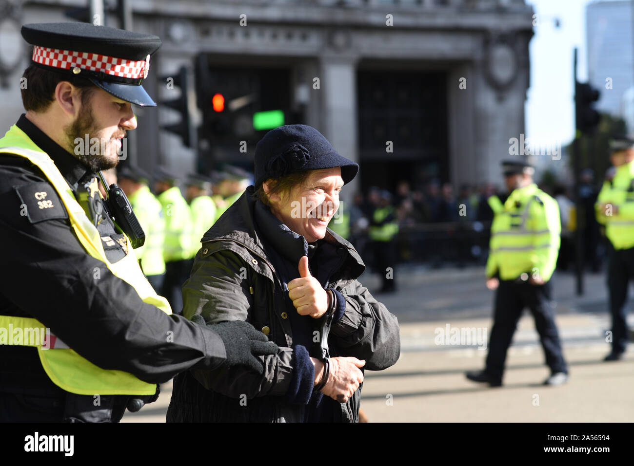 London, UK. 18th Oct, 2019. A climate change activist in handcuffs ...