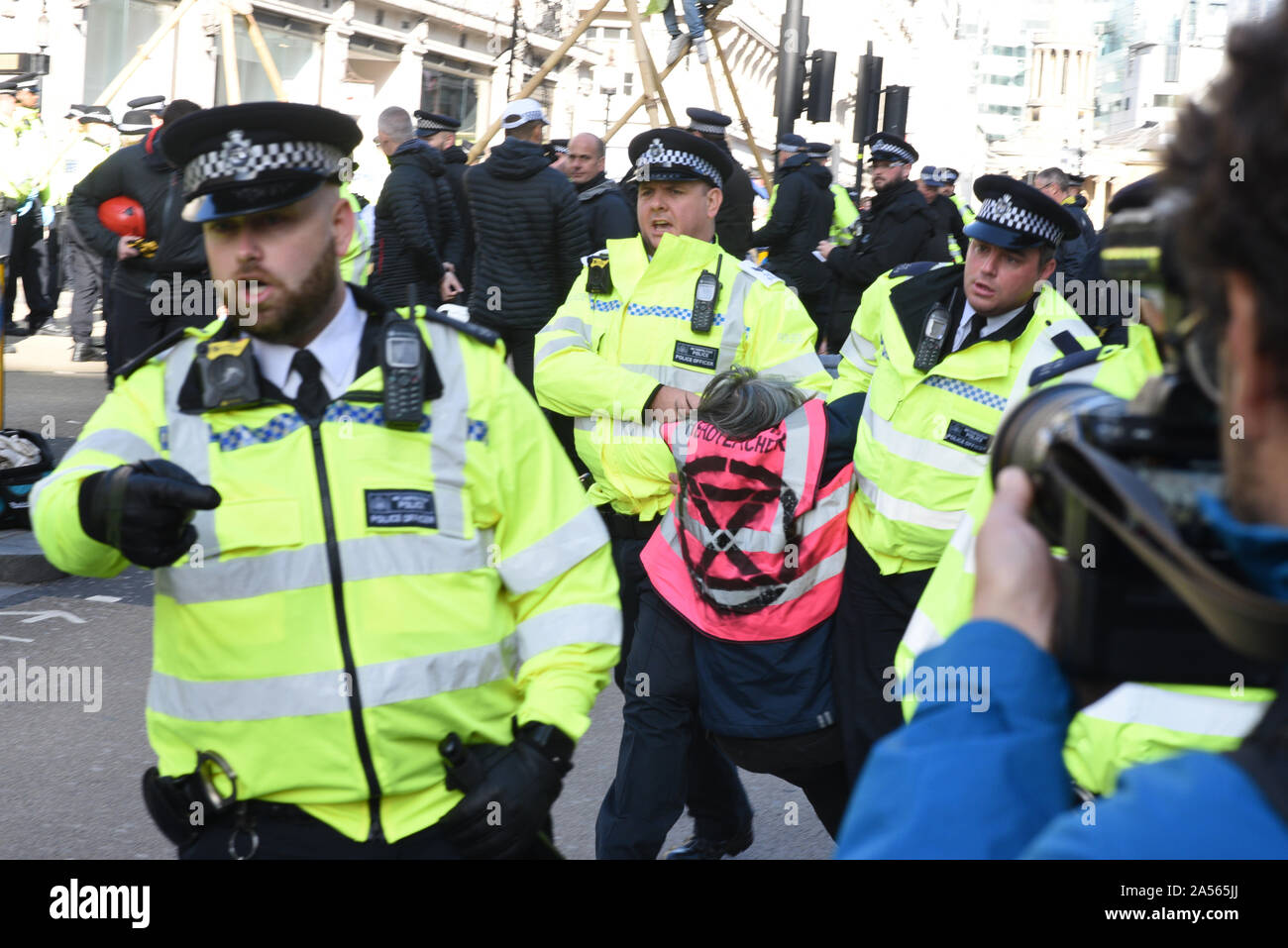 London, UK. 18th Oct, 2019. A climate change protestor is carried by ...