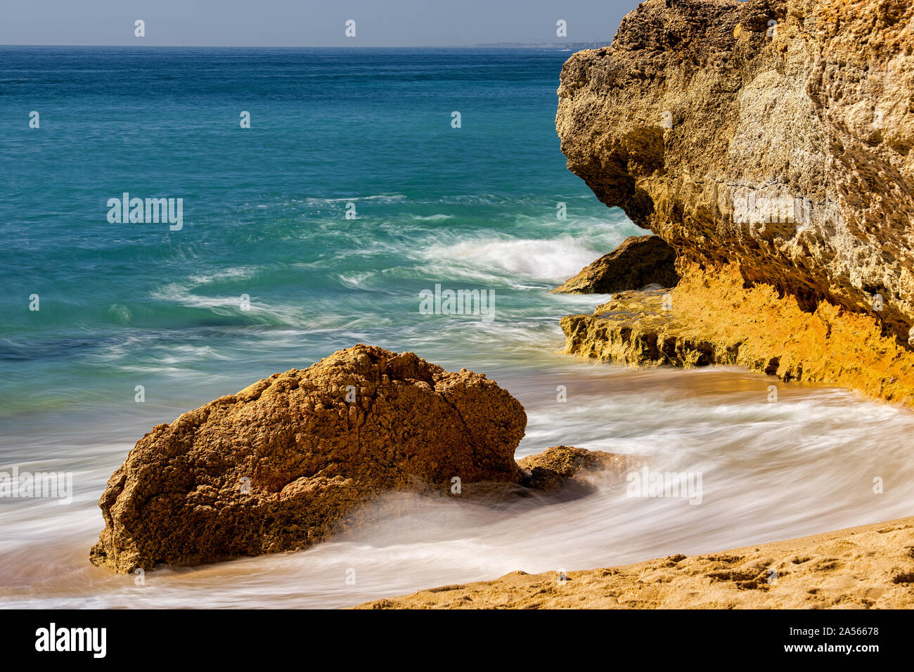 A wave retreating from the cliffs near the beach Stock Photo - Alamy