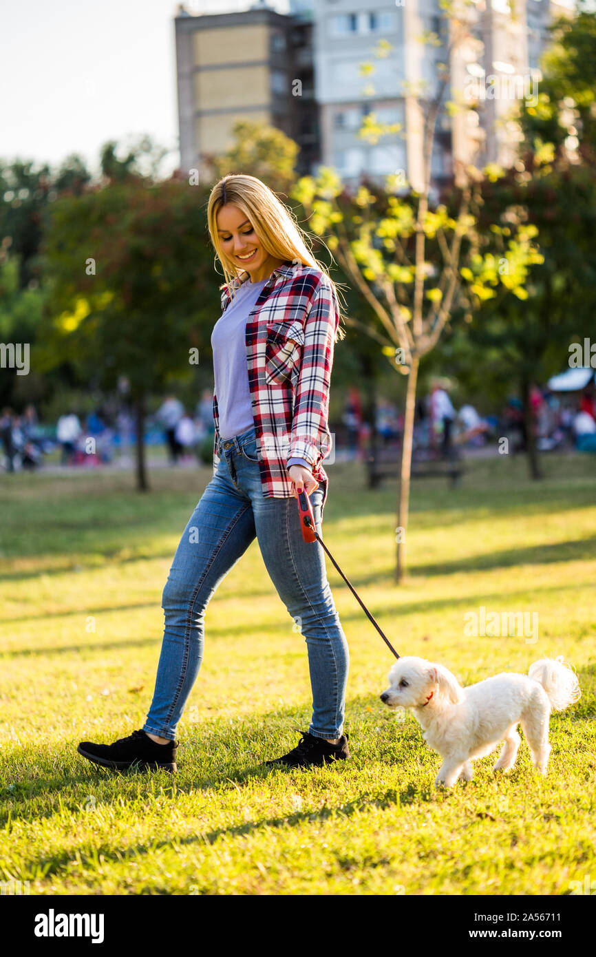 Beautiful woman walking maltese hi-res stock photography and images - Alamy