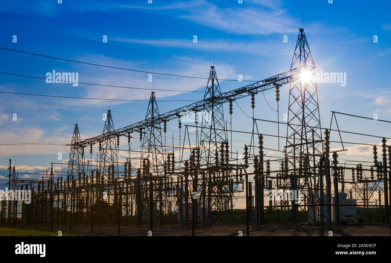 Sunset behind substation towers Stock Photo - Alamy