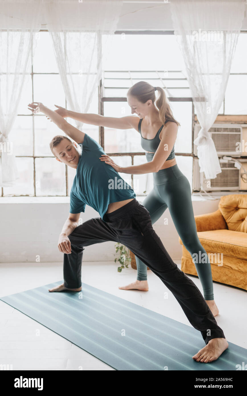 Yoga instructor teaching yoga in studio Stock Photo - Alamy