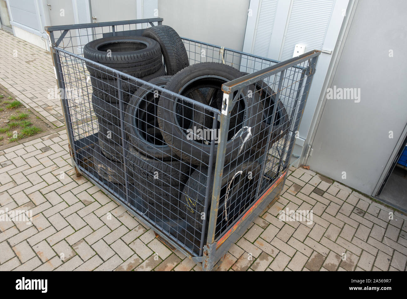 Many old tyres pile up in front of a garage to be disposed of Stock ...