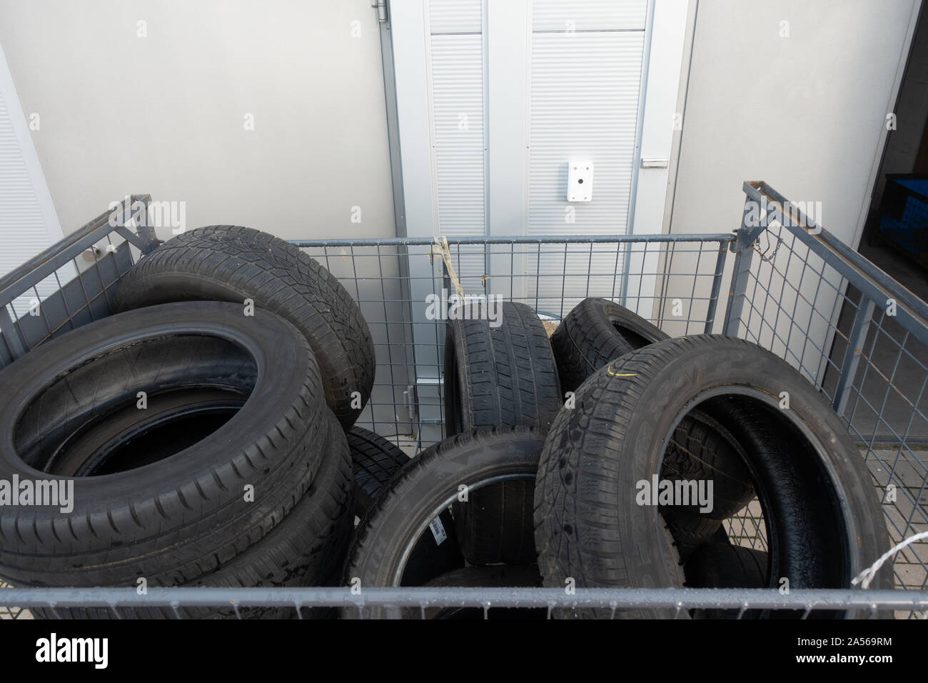 Many old tyres pile up in front of a garage to be disposed of Stock ...