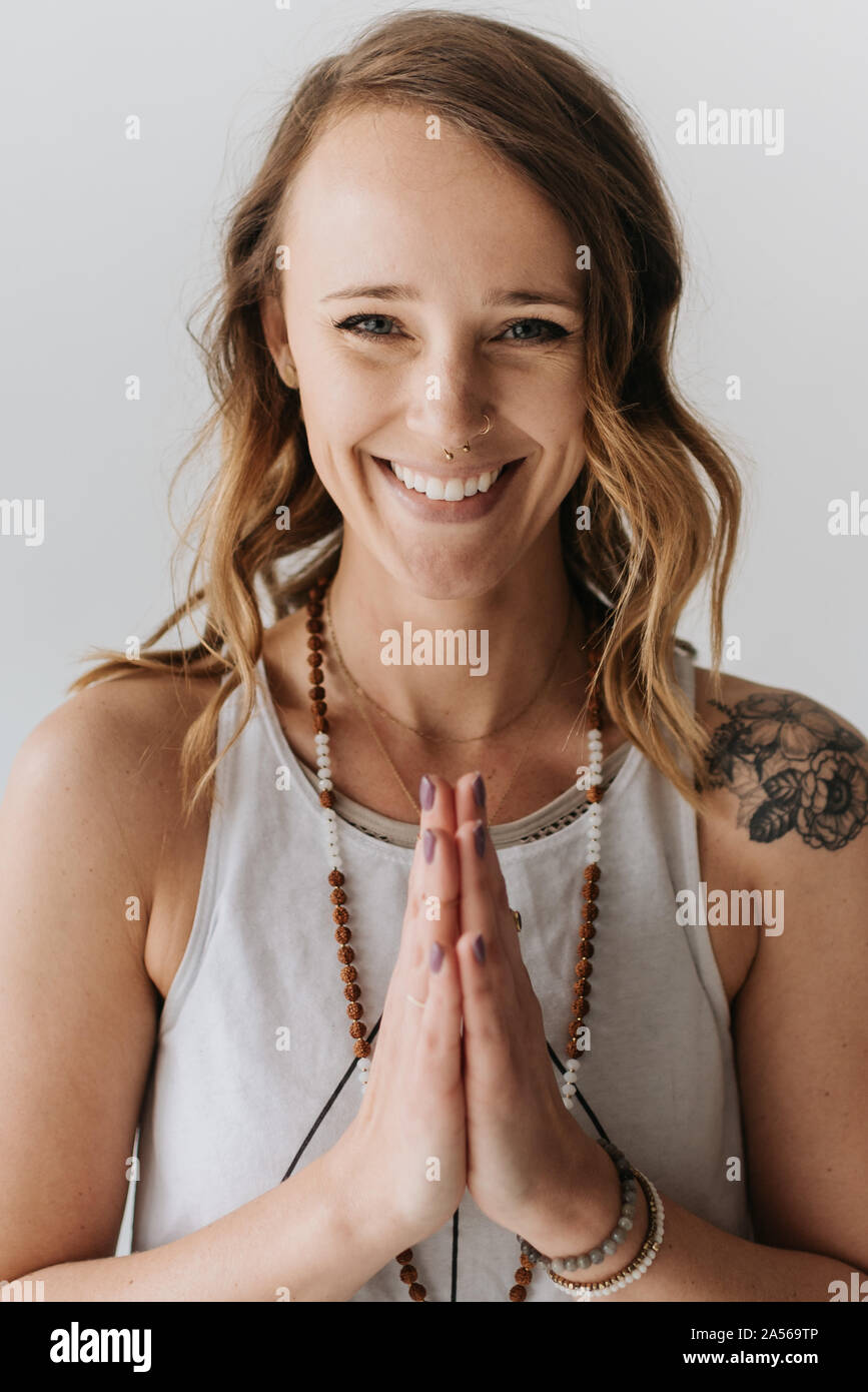 Portrait of woman in prayer pose Stock Photo - Alamy