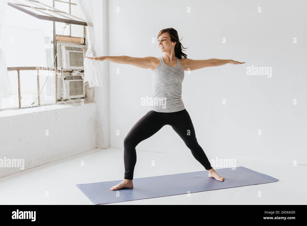 Woman yoga studio warrior hi-res stock photography and images - Alamy
