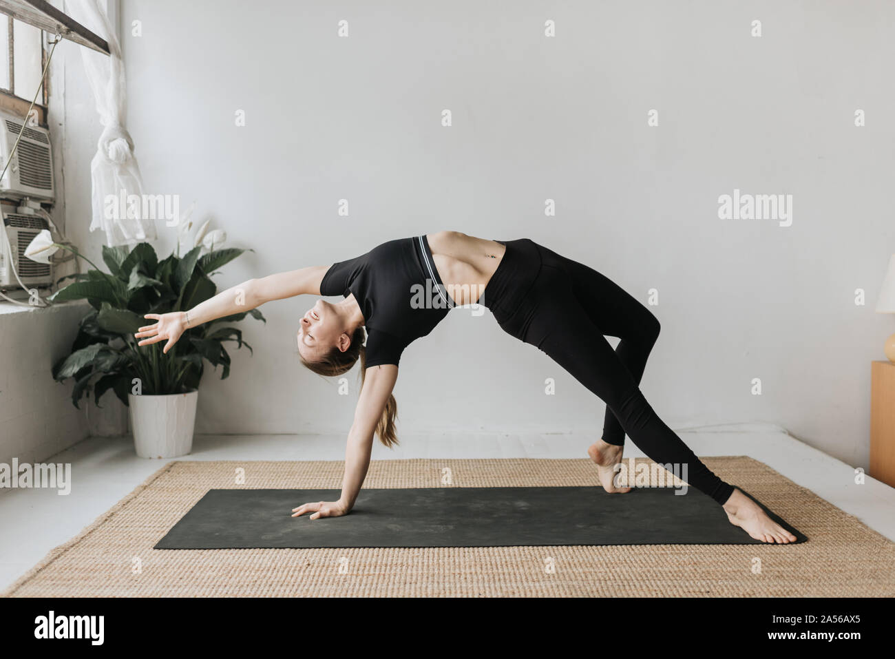 Young women in yoga poses hi-res stock photography and images - Alamy
