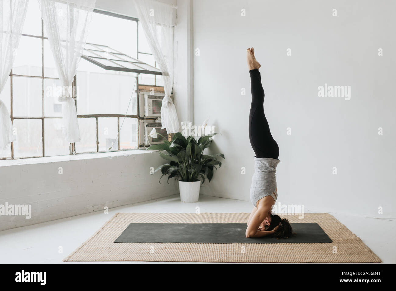 Woman practising yoga in studio Stock Photo - Alamy