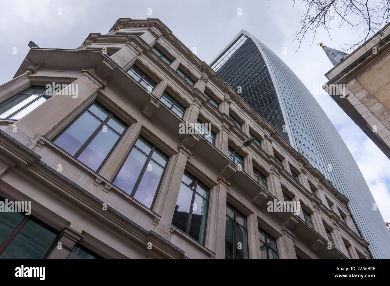 Fantastic classic architecture in City of London with skyscrapers in background. Iconic office ...
