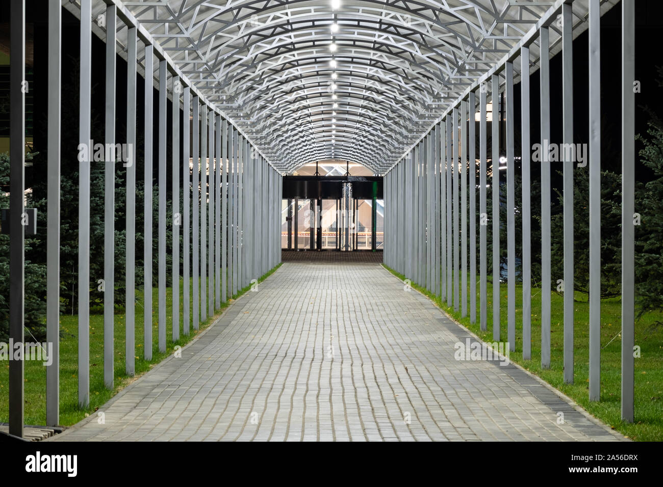 Futuristic pedestrian overpass tunnel with bright lighting, receding ...