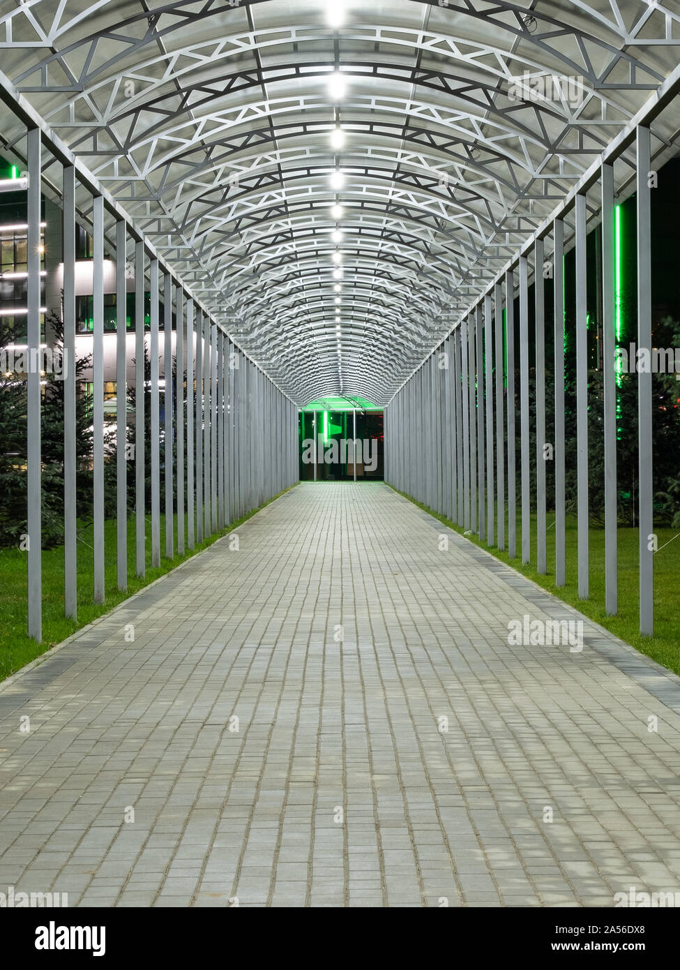 Futuristic pedestrian overpass tunnel with bright lighting, receding ...