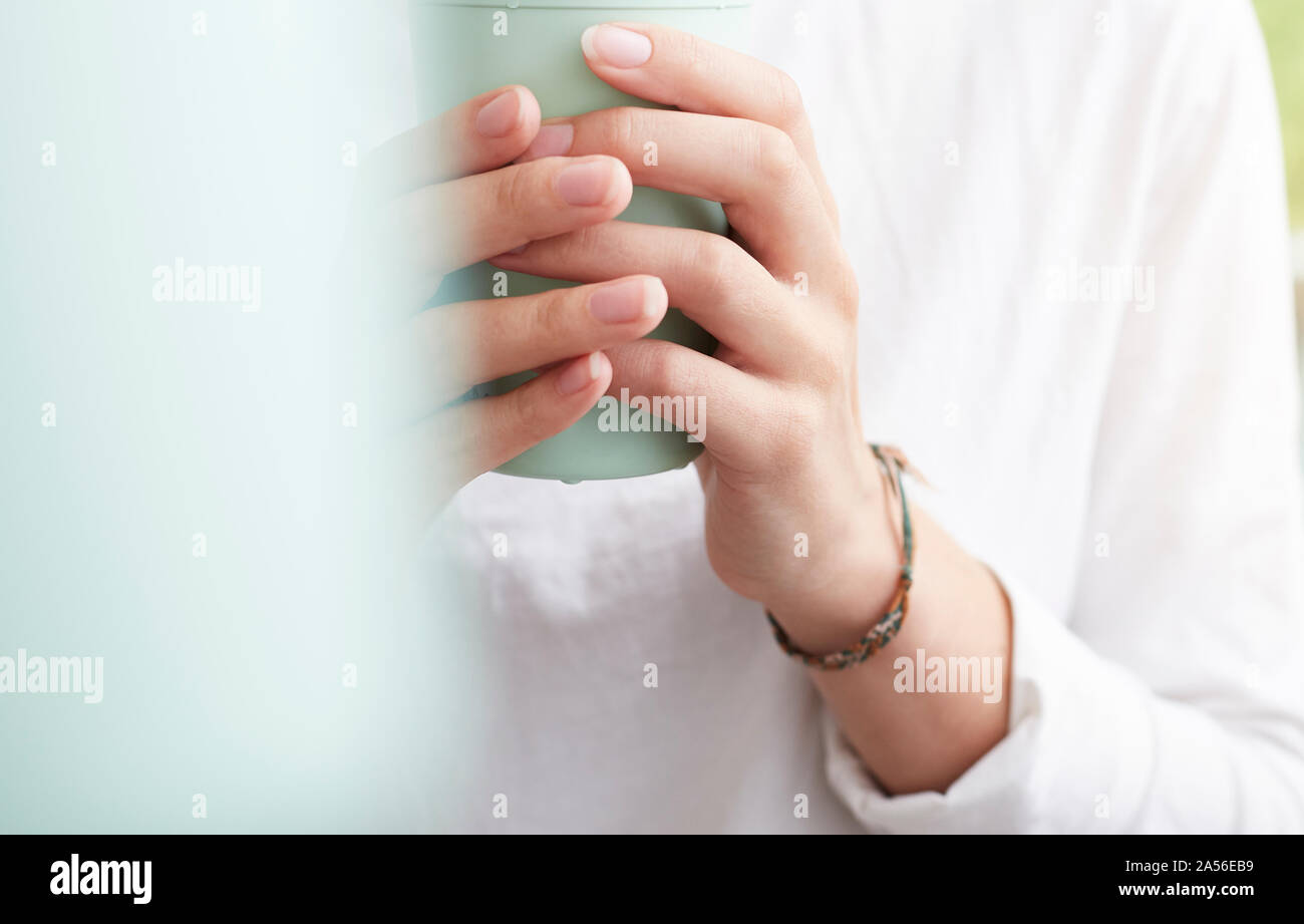 Woman using reusable coffee cup Stock Photo - Alamy