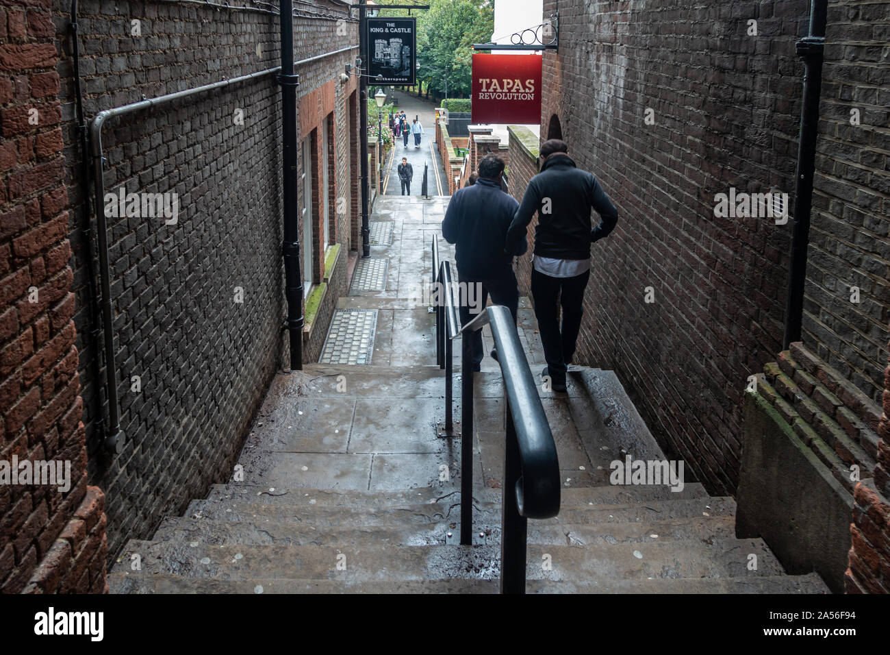 Looking down a flight of stairs in a narrow alleyway in Windsor, UK ...
