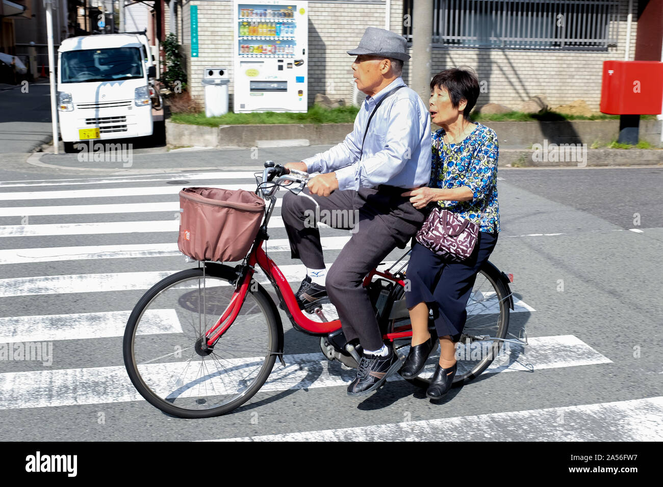 An elderly couple riding a bicycle in Osaka, Japan Stock Photo - Alamy