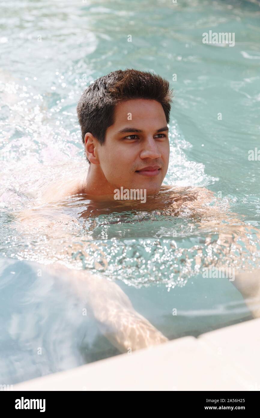 Man swimming to edge of pool Stock Photo - Alamy
