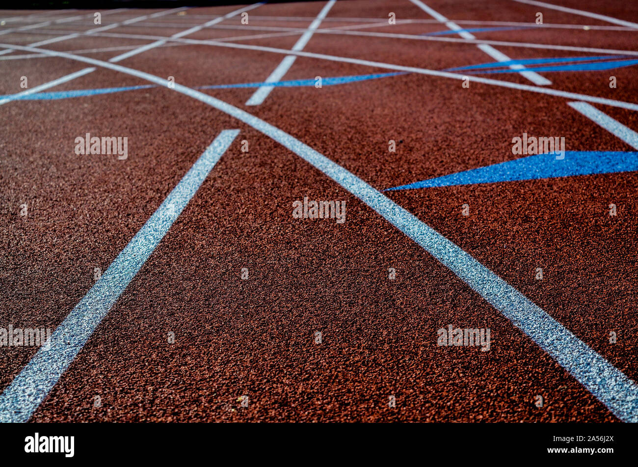 Track and Field surface with white lines and orange gravel Stock Photo ...