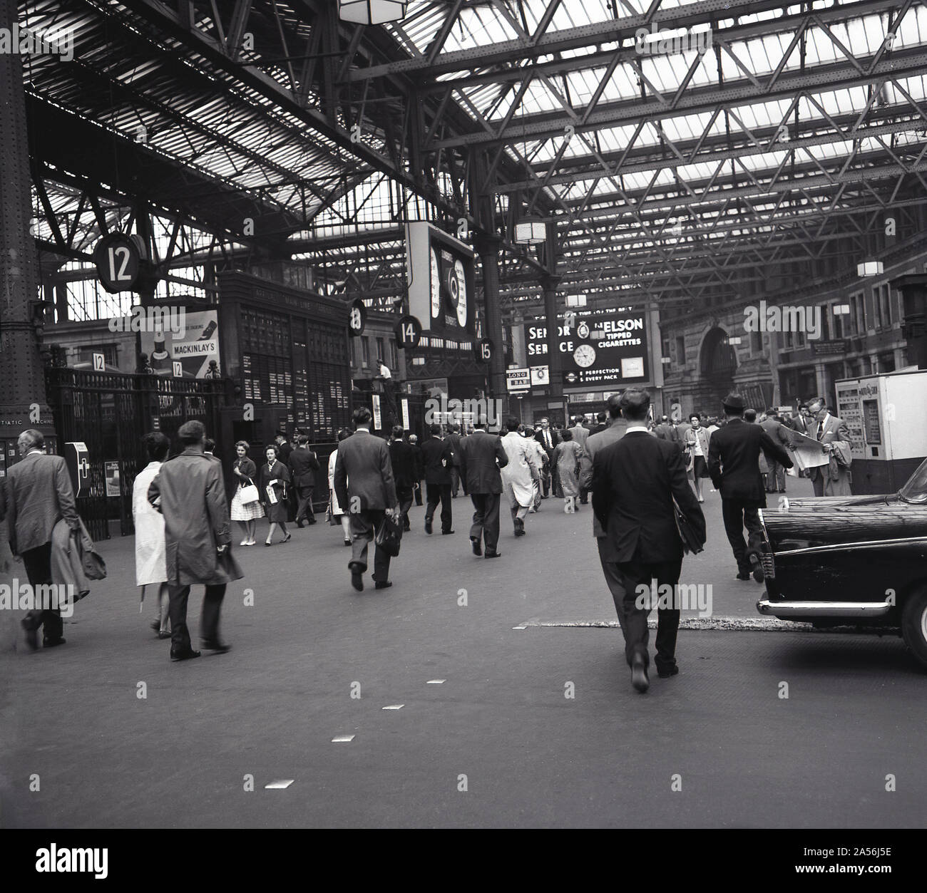 1960s, historical, rail commuters on the covered concourse at Waterloo ...