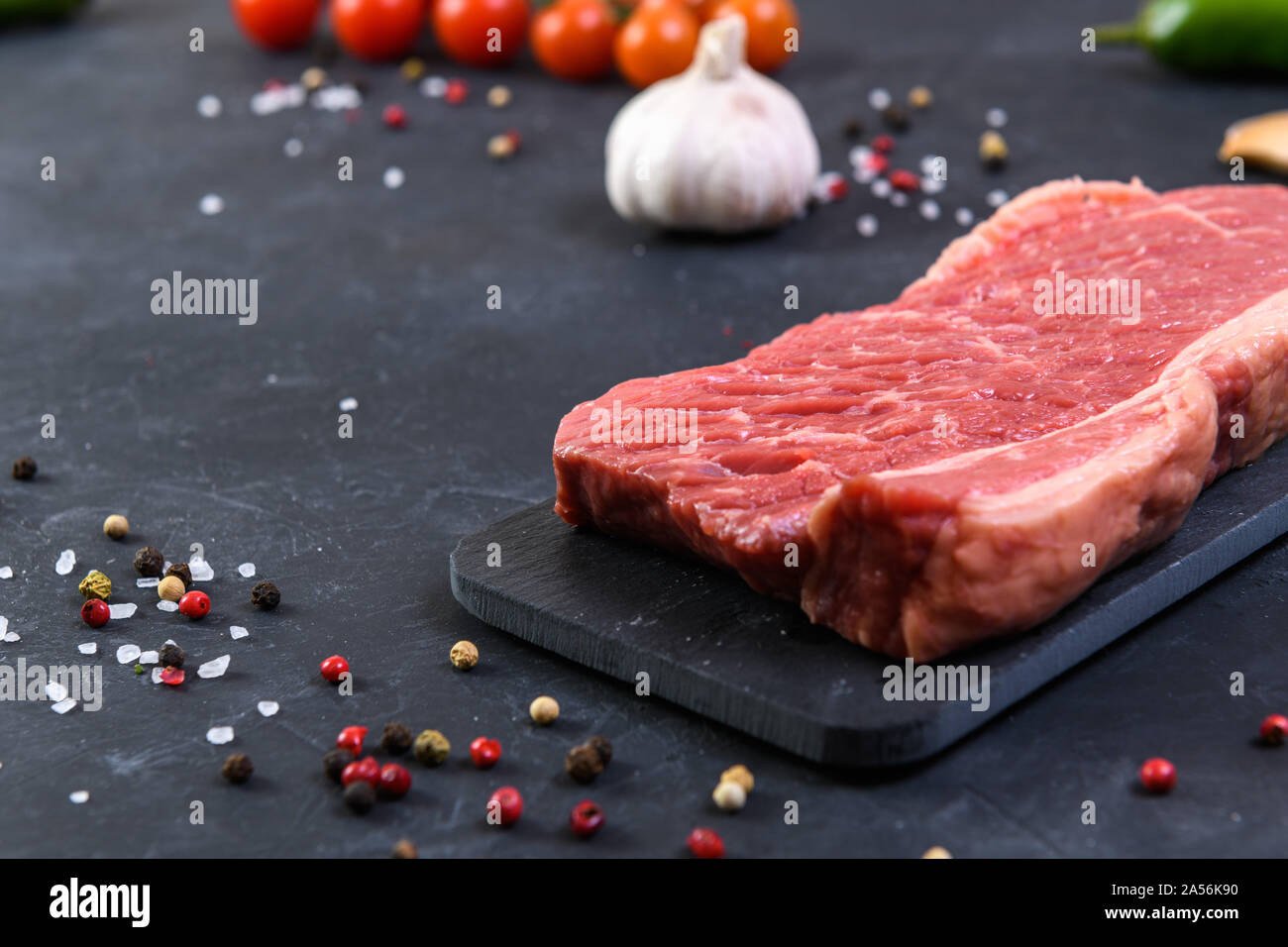Raw fresh marbled meat and seasonings on dark background Stock Photo ...