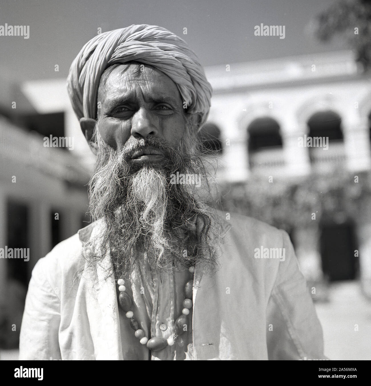 1950s, historical, a portrait of an elderly Indian man, wearing a cloth ...