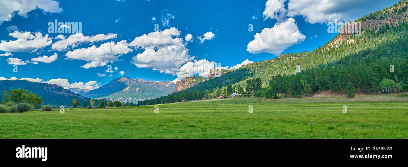 Panoramic View of Alpine Meadow with Farm Stock Photo - Alamy