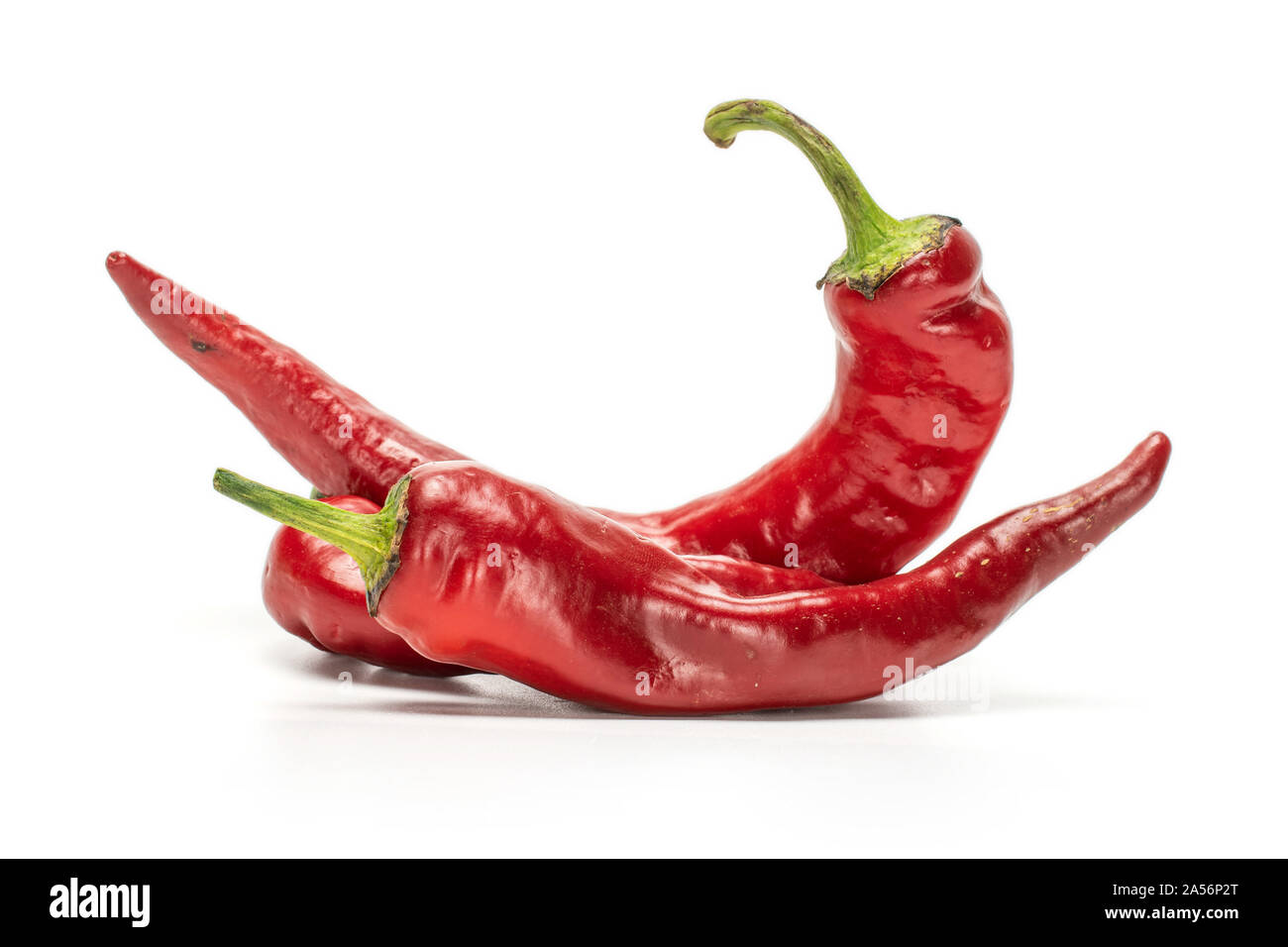 Group of two whole dark red fresh hot pepper isolated on white ...