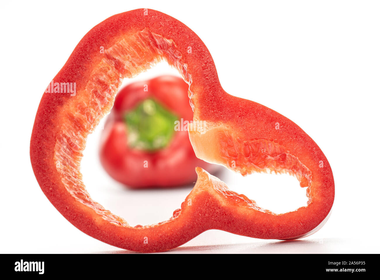 Group of one whole one slice of sweet red bell pepper front focus ...
