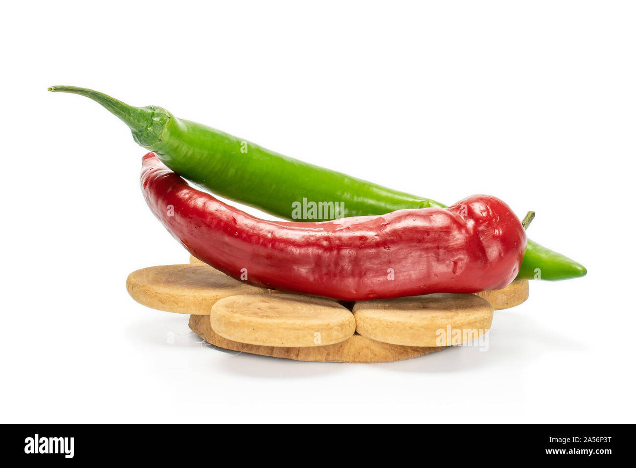 Group of two whole fresh hot pepper on tree stump isolated on white ...