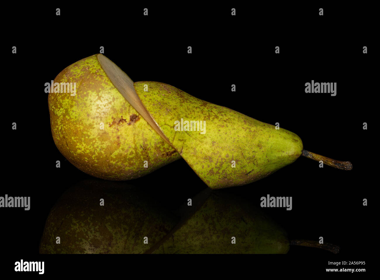 Group of two halves of fresh green pear conference isolated on black ...